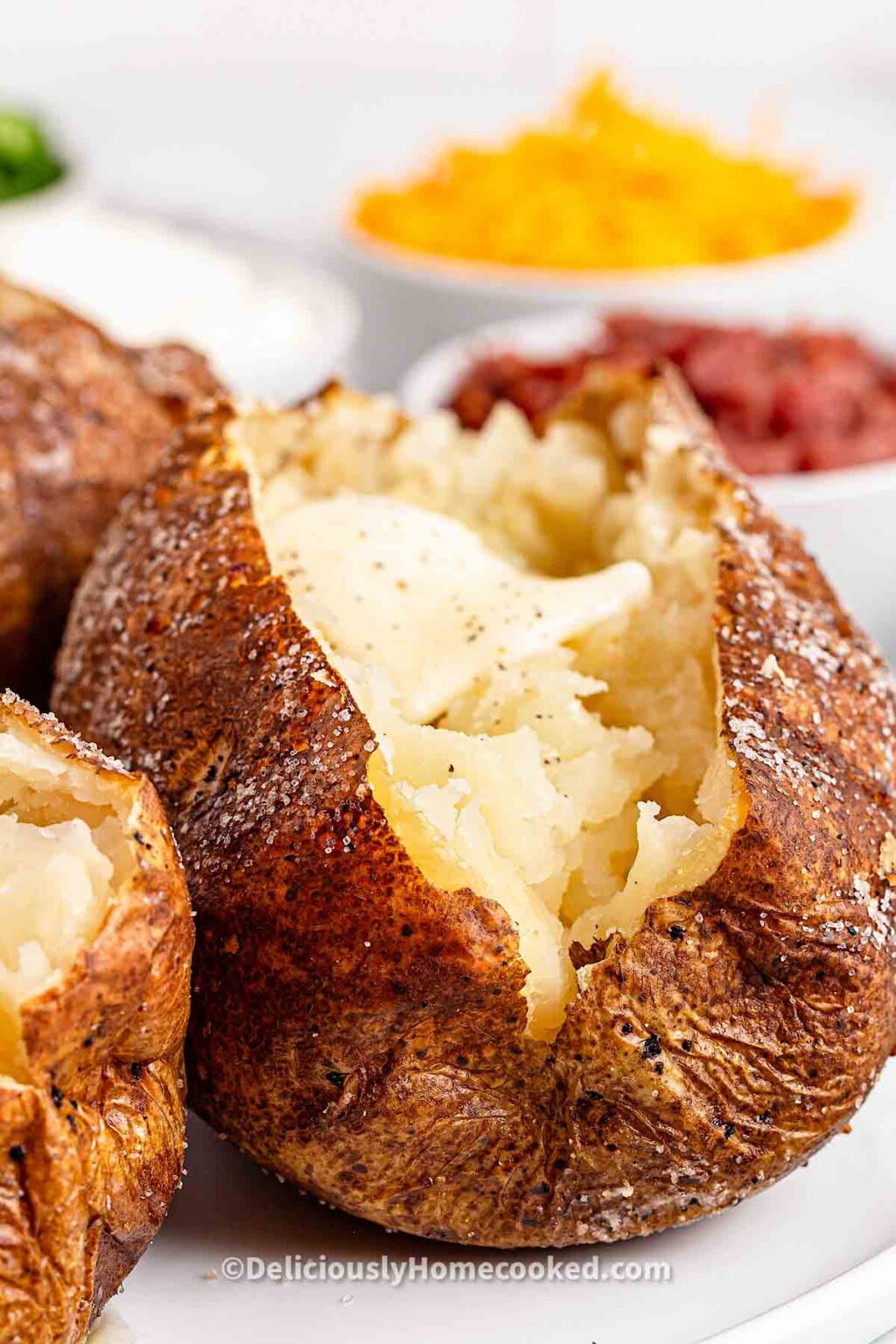Loaded baked potatoes with bacon and cheese - Deliciously Home Cooked